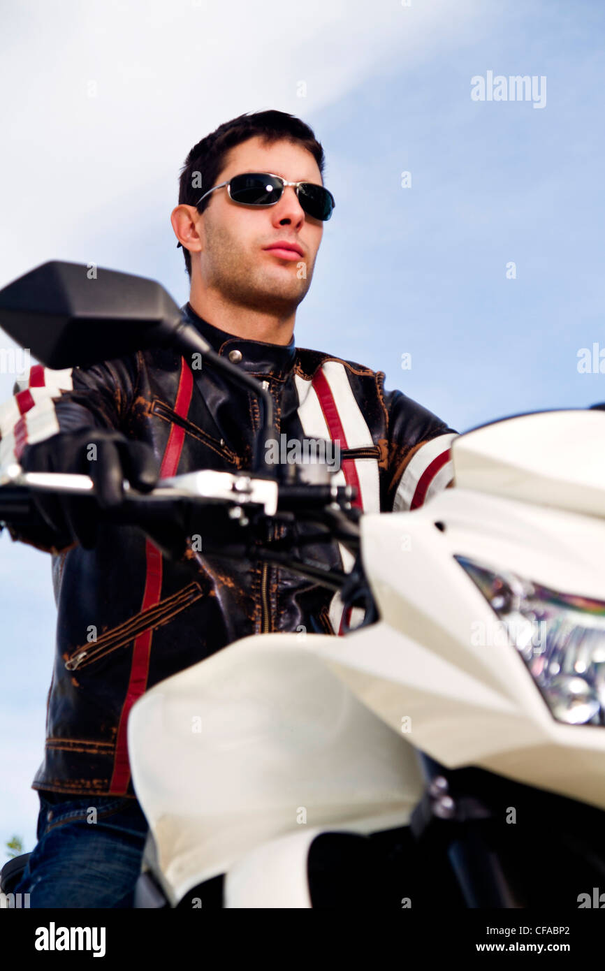 View of a man with a motorcycle on a asphalt road Stock Photo - Alamy
