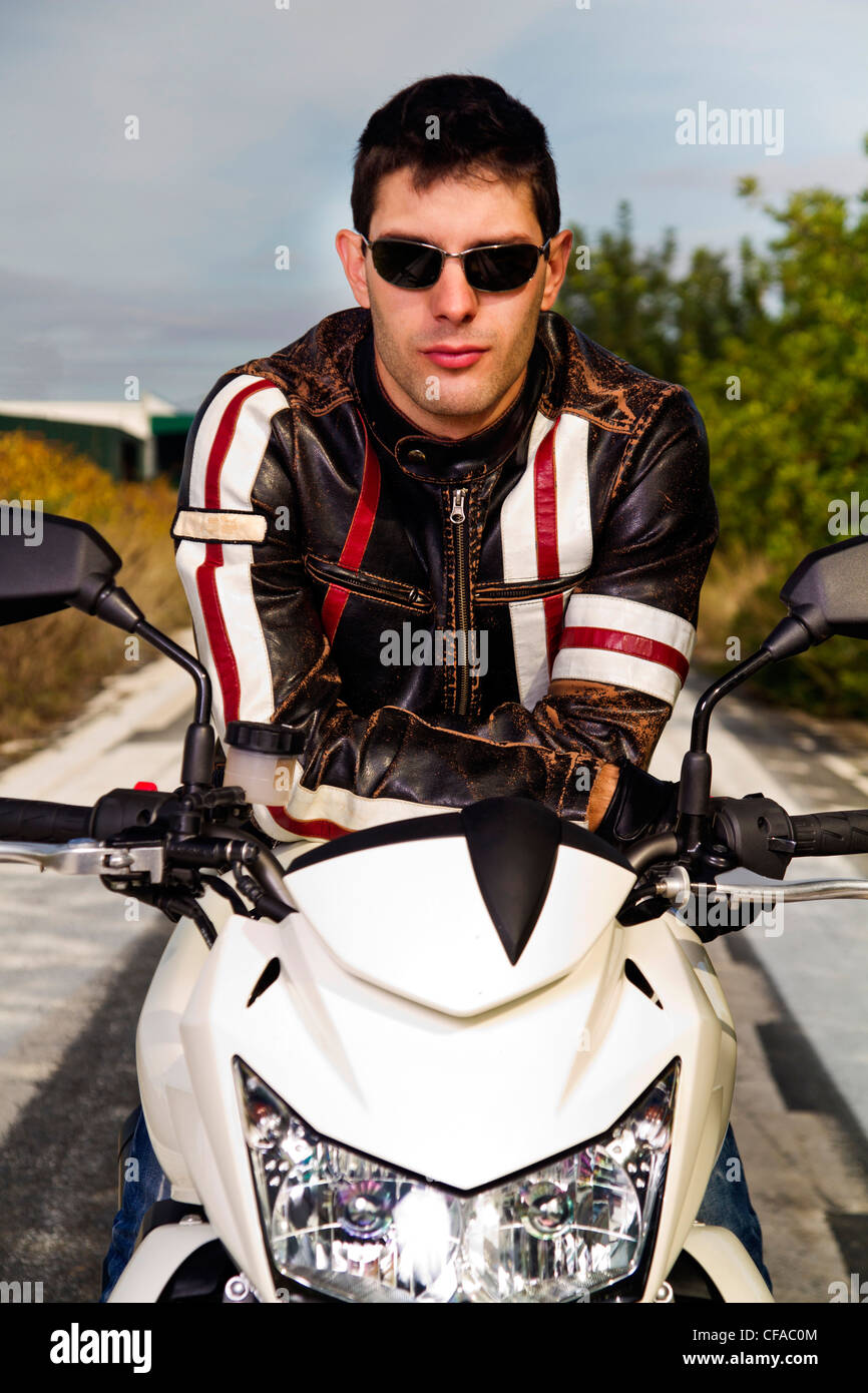 View of a man with a motorcycle on a asphalt road Stock Photo - Alamy
