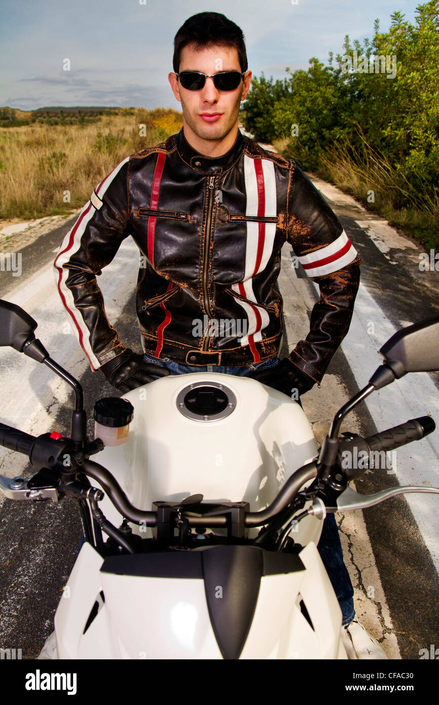 View of a man with a motorcycle on a asphalt road Stock Photo - Alamy