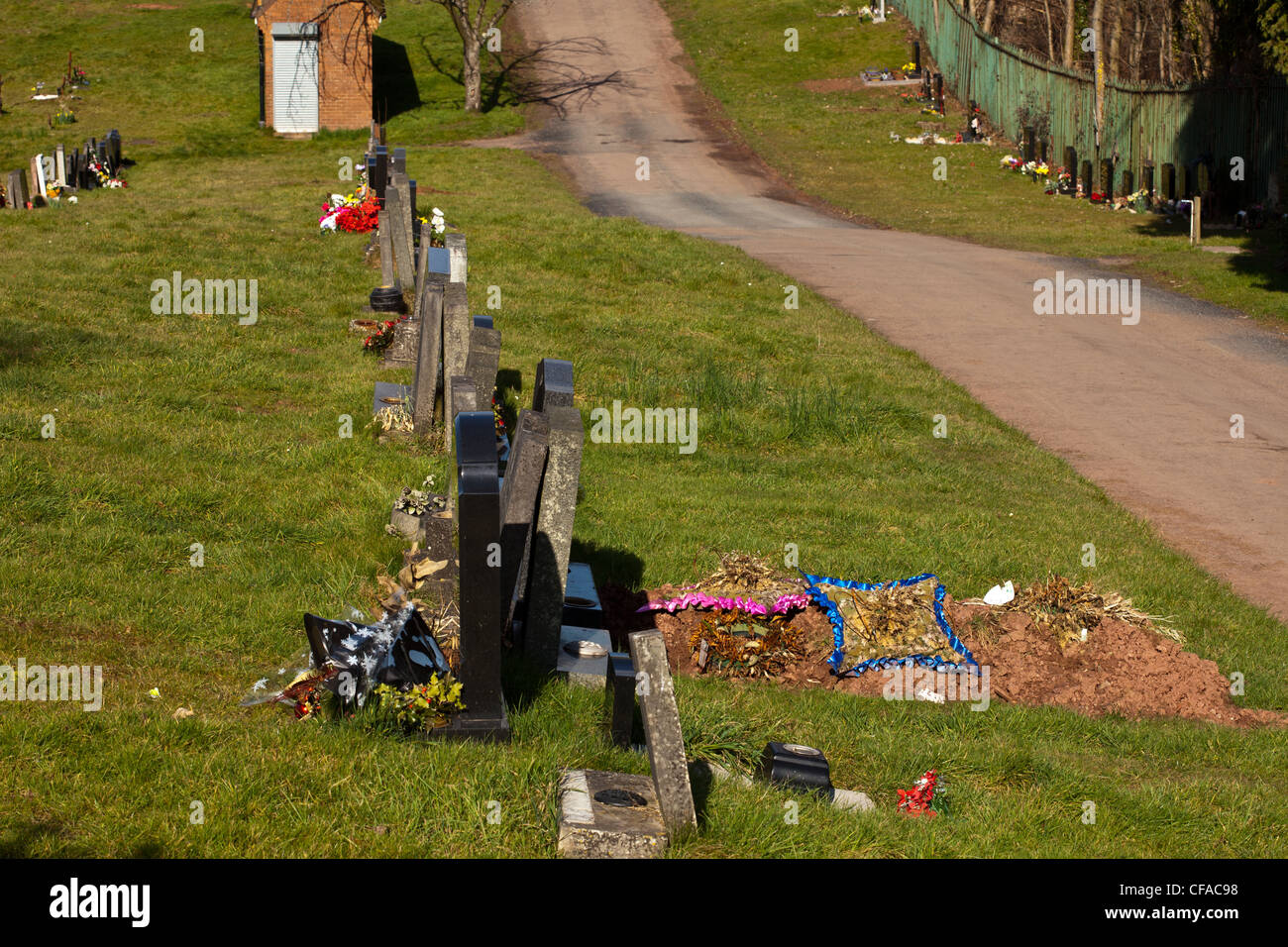 head stones in cemetery with fresh cut flowers,gravestones in graveyard ...