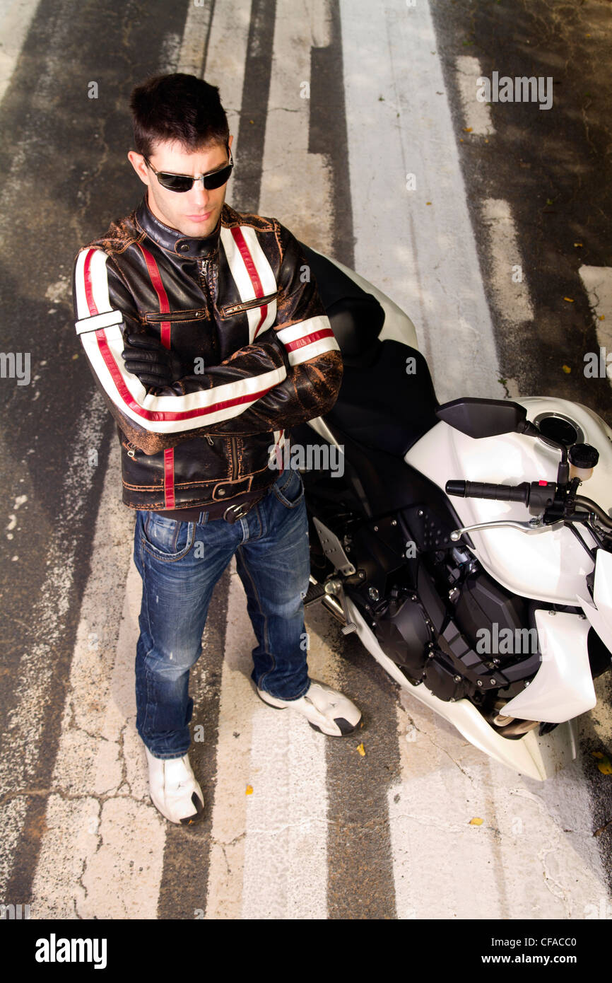 View of a man with a motorcycle on a asphalt road Stock Photo - Alamy