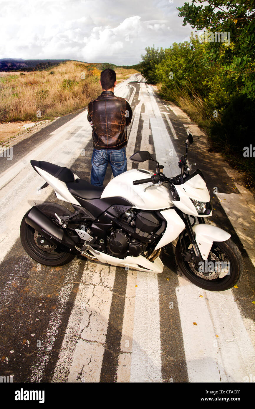 View of a man with a motorcycle on a asphalt road Stock Photo - Alamy
