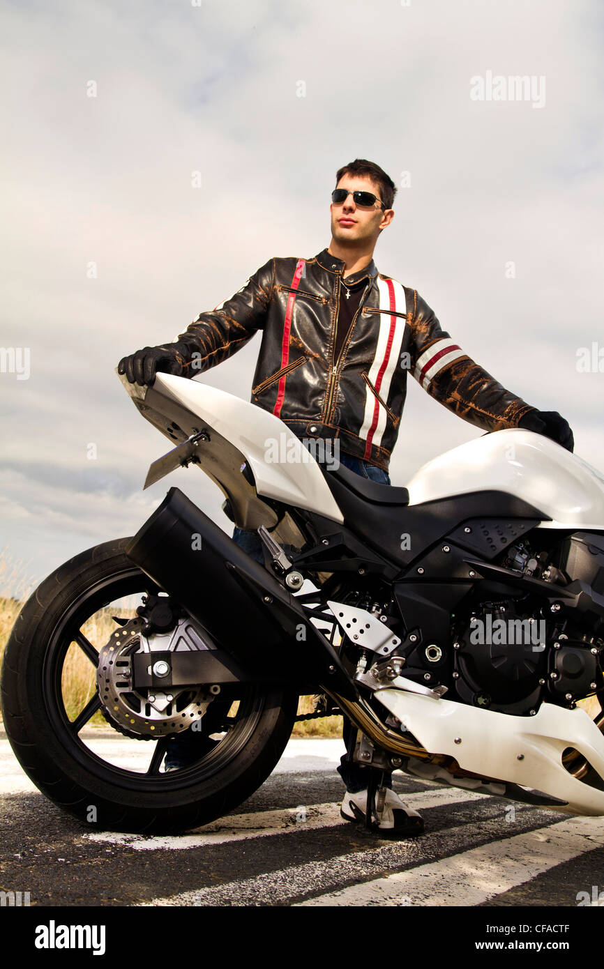 View of a man with a motorcycle on a asphalt road Stock Photo - Alamy