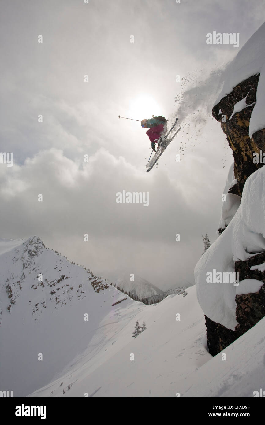 a female skier jumps a cliff, Kicking Horse Backcountry, BC Stock Photo ...