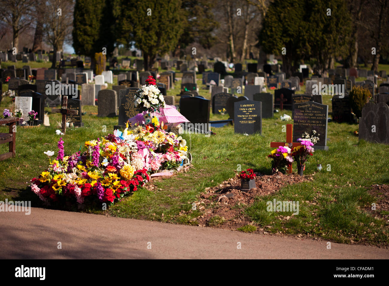Childs grave covered in freshflowers hi-res stock photography and ...