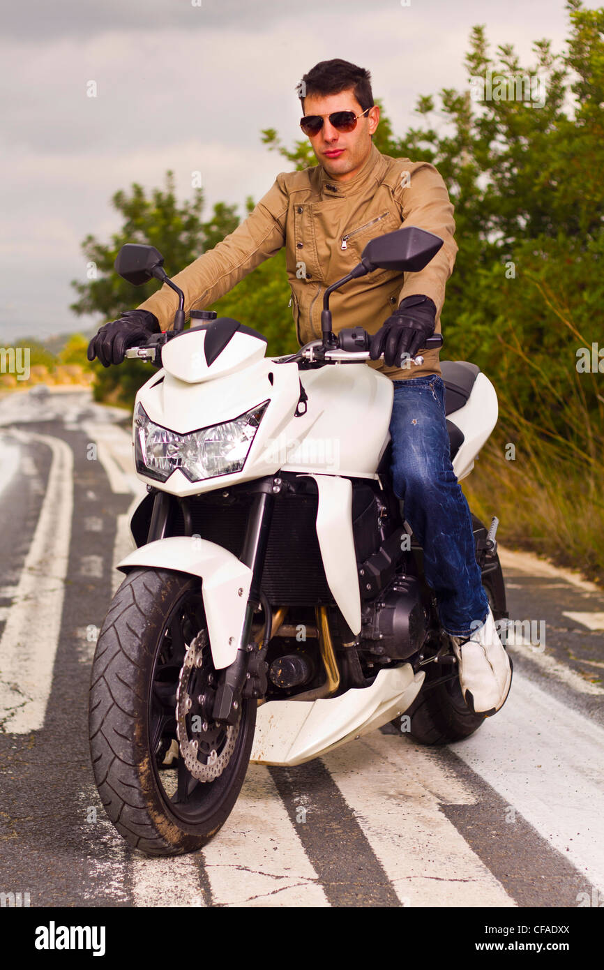 View of a man with a motorcycle on a asphalt road Stock Photo - Alamy
