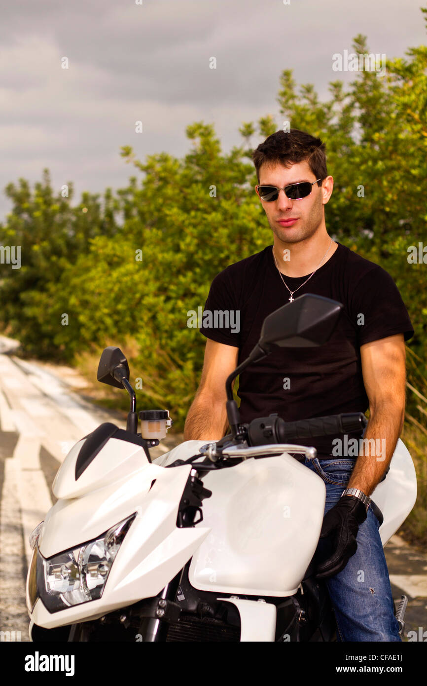 View of a man with a motorcycle on a asphalt road Stock Photo - Alamy