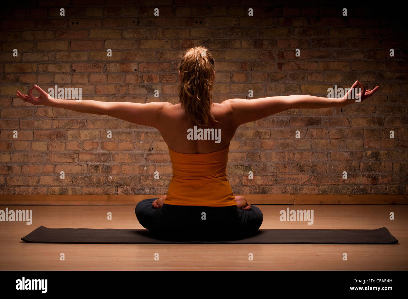 Woman practicing yoga on mat Stock Photo - Alamy