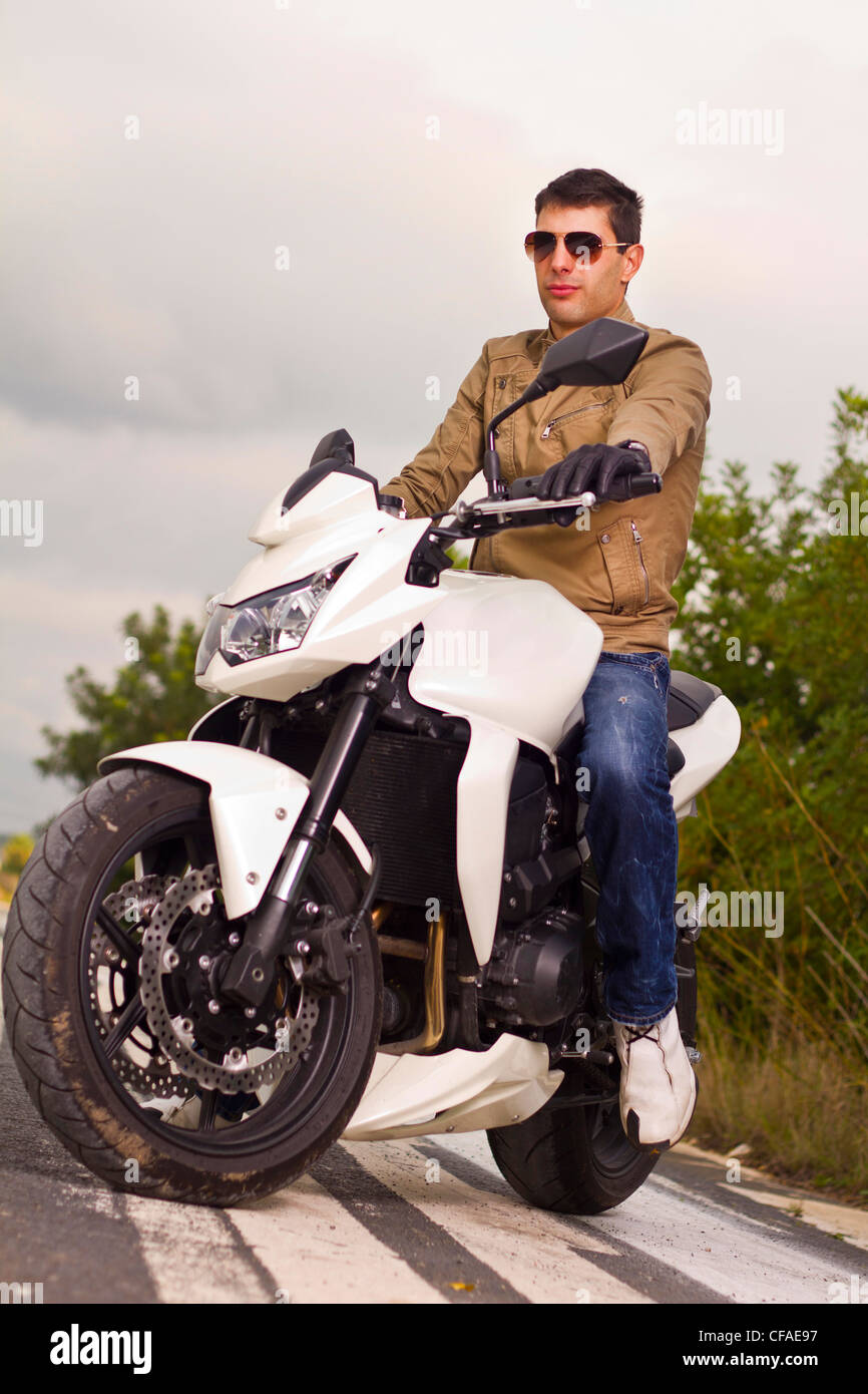 View of a man with a motorcycle on a asphalt road Stock Photo - Alamy