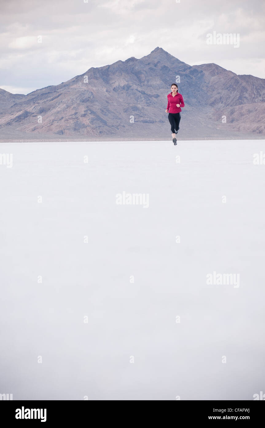 Woman running in desert landscape Stock Photo - Alamy