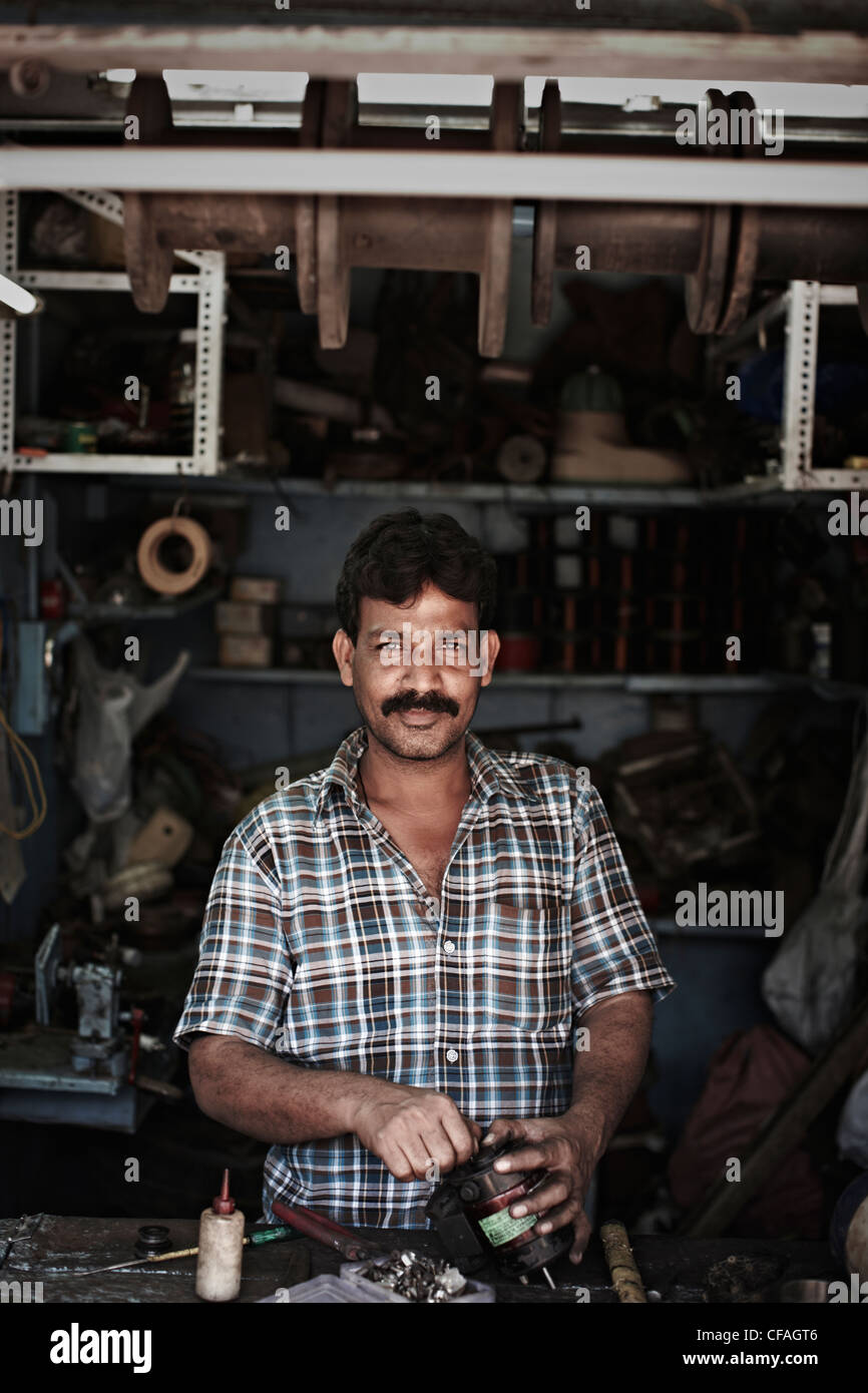 Man working with machinery in shop Stock Photo - Alamy