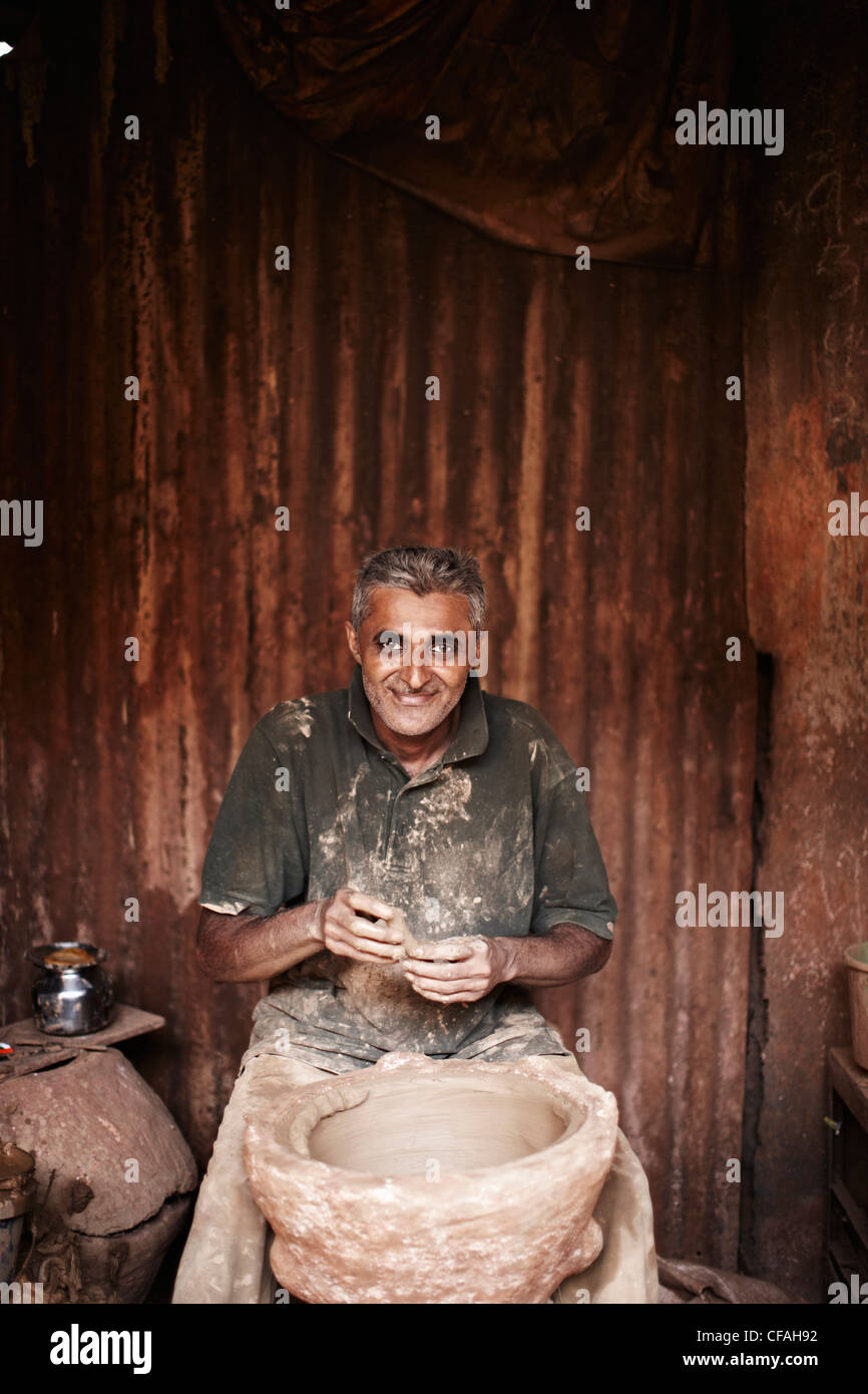 Smiling man working with pottery Stock Photo - Alamy
