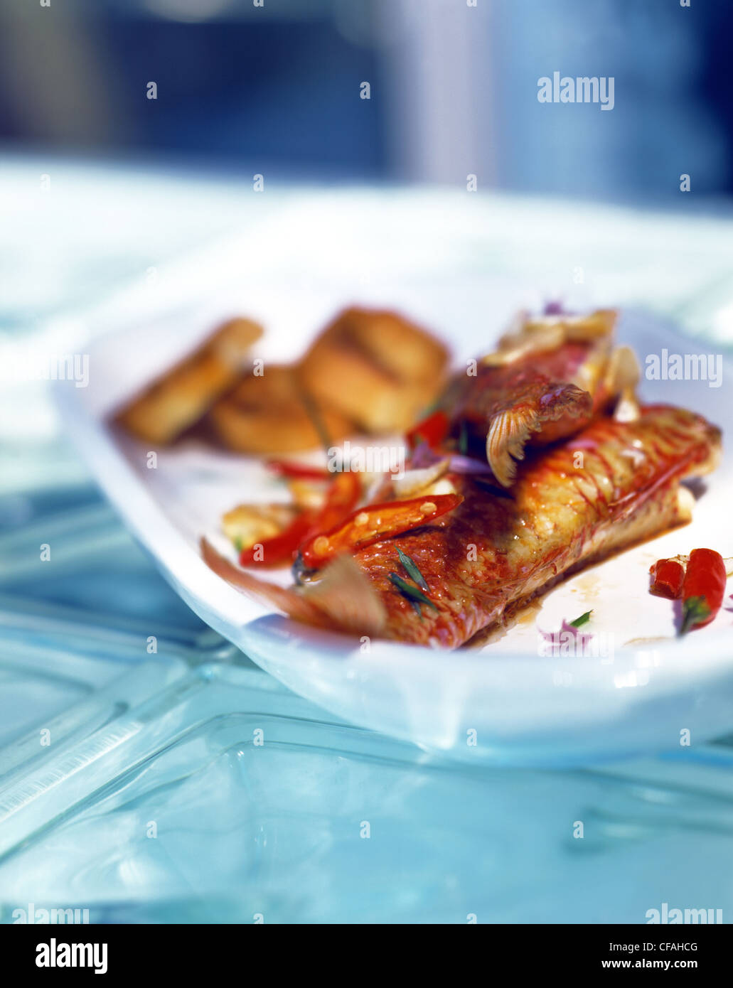 Fried red barbel with roasted bread slices Stock Photo - Alamy