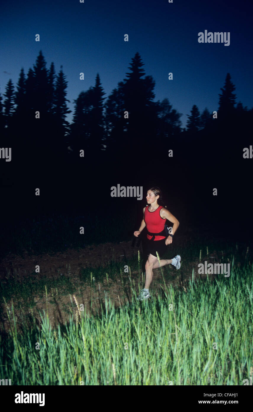 Woman running at night, Banff, Alberta, Canada Stock Photo - Alamy