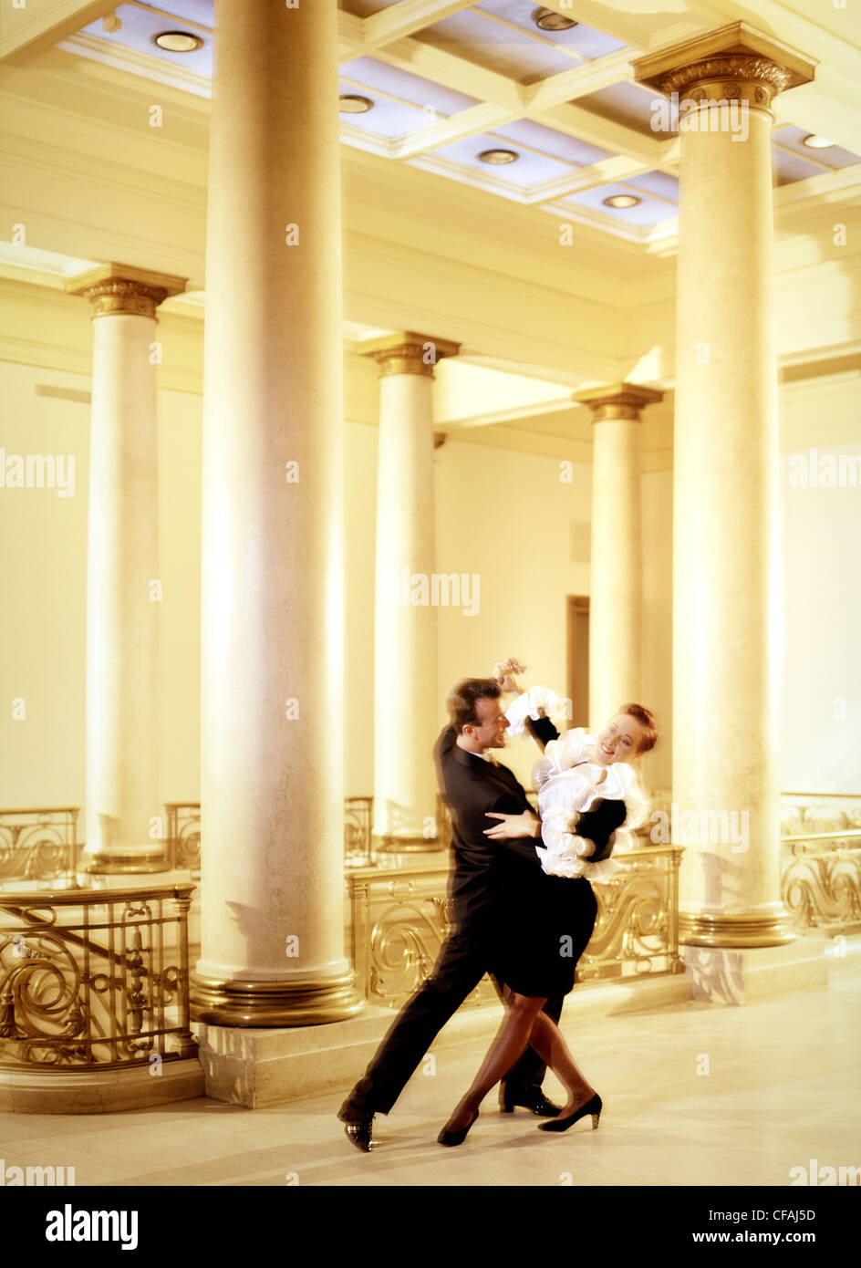 couple ballroom dancing with marble columns and floor and wrought iron ...