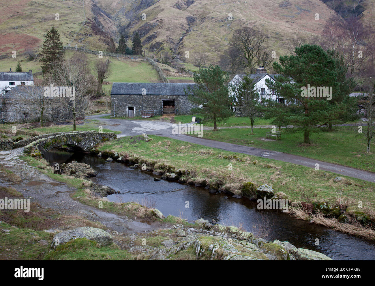 Watendlath Beck flowing under an arch bridge at Watendlath farm, near ...