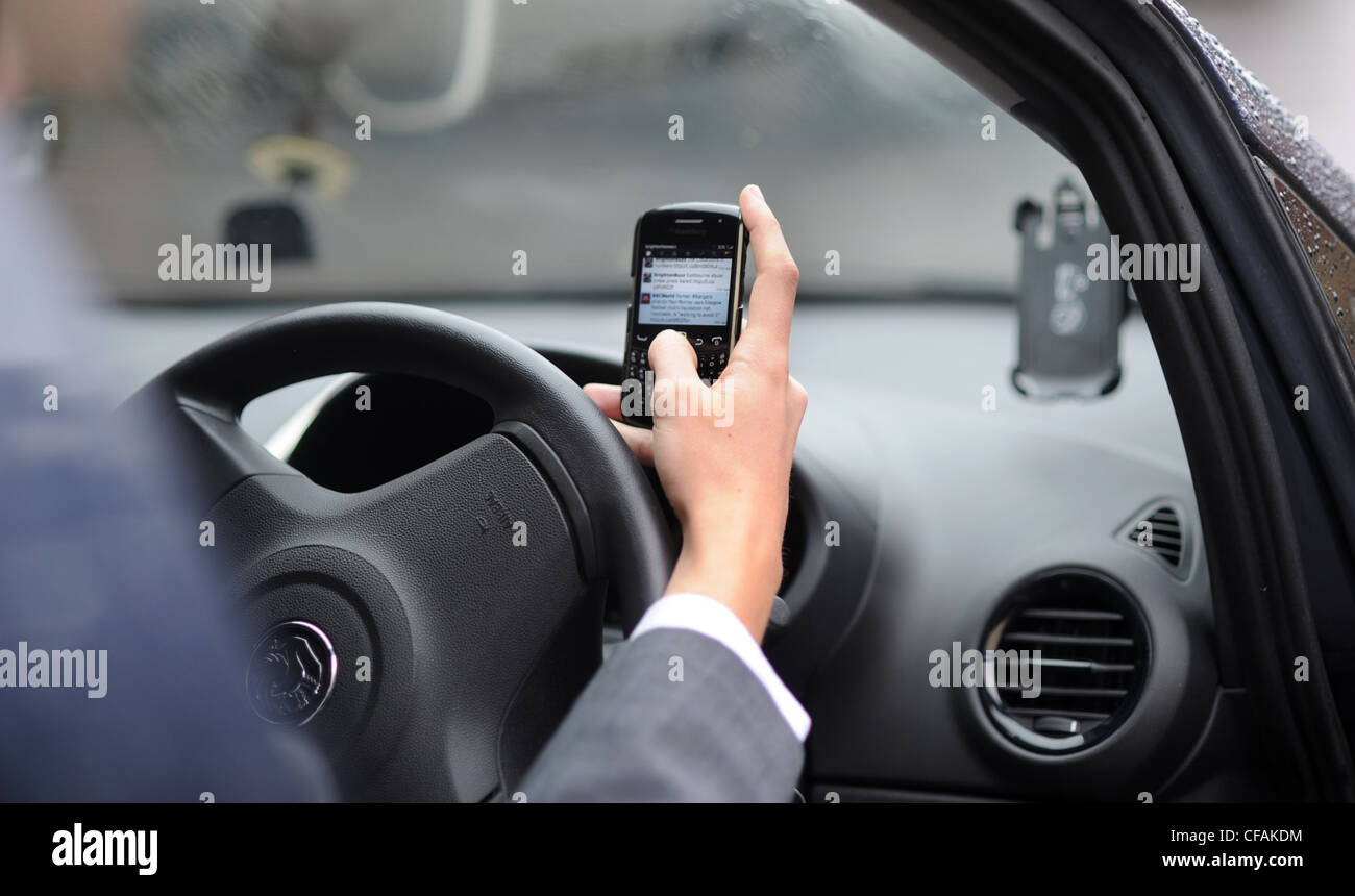 Posed by model man using his mobile phone while driving hi-res stock ...