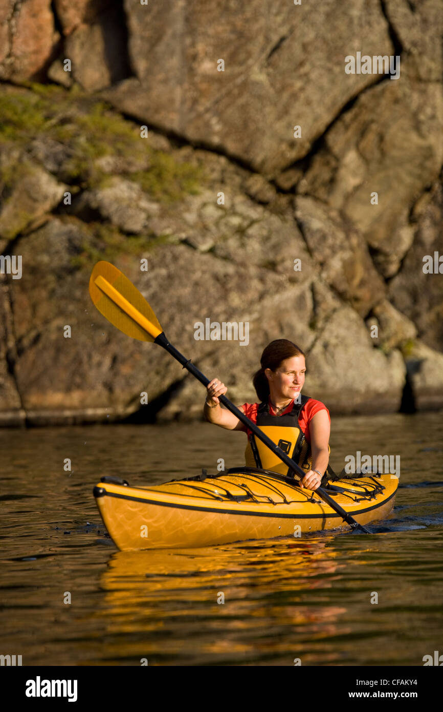 Young woman sea kayaking through Gull Narrows near Gravenhurst, Muskoka ...