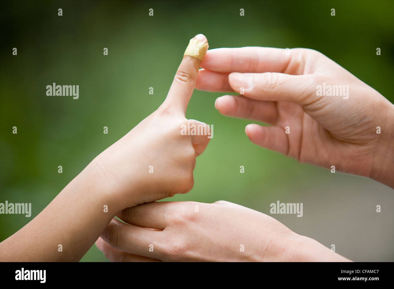 Sticking a patch on an injured finger Stock Photo - Alamy