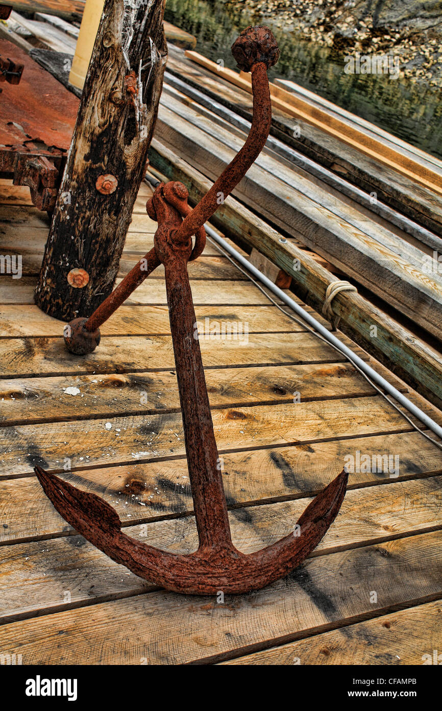 A rusty anchor sits on the dock Stock Photo - Alamy