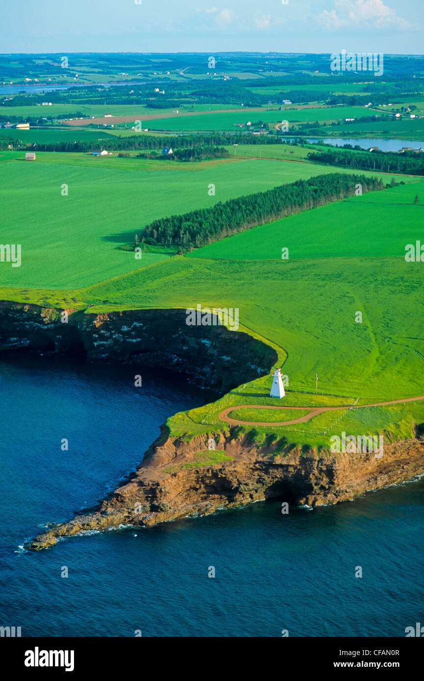 Aerial view of Cape Tryon Lighthouse and farmland on the coast of ...