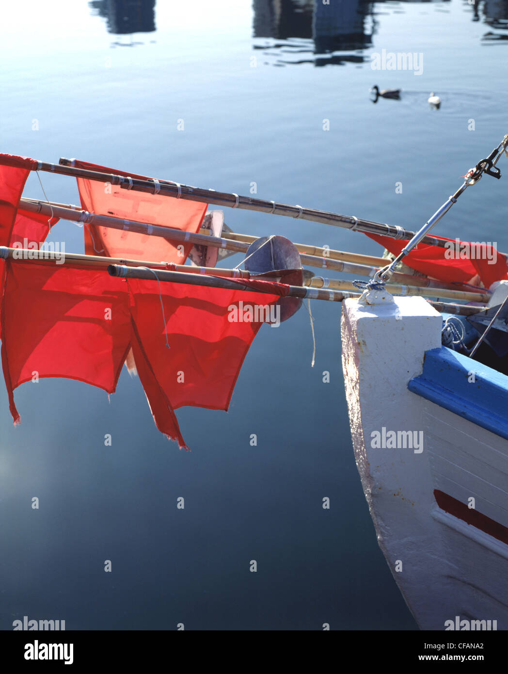 Still: red flags at the bow of the fishcutter Stock Photo - Alamy