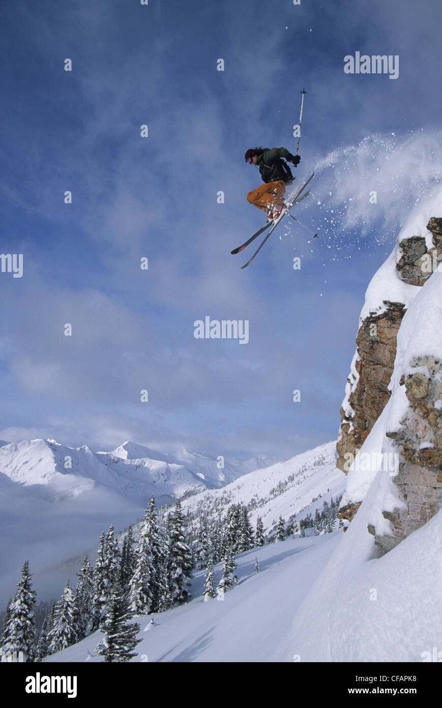 A skier jumping a cliff in the backcountry of Kickinghorse Resort ...