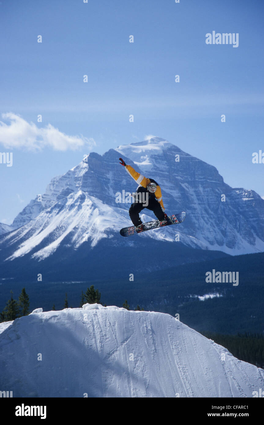 A snowboarder catching some air at Lake Louise resort, Banff National ...