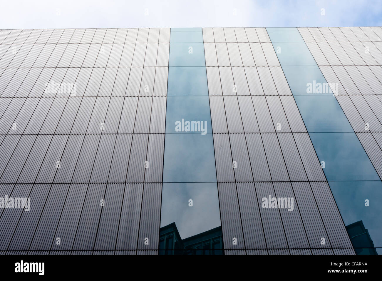Sky detail on windows of office building shows an artistic and ...