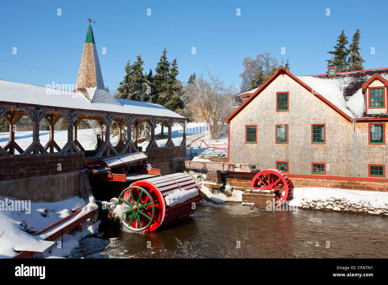 Mill and covered bridge in winter along Hunter River, Prince Edward ...