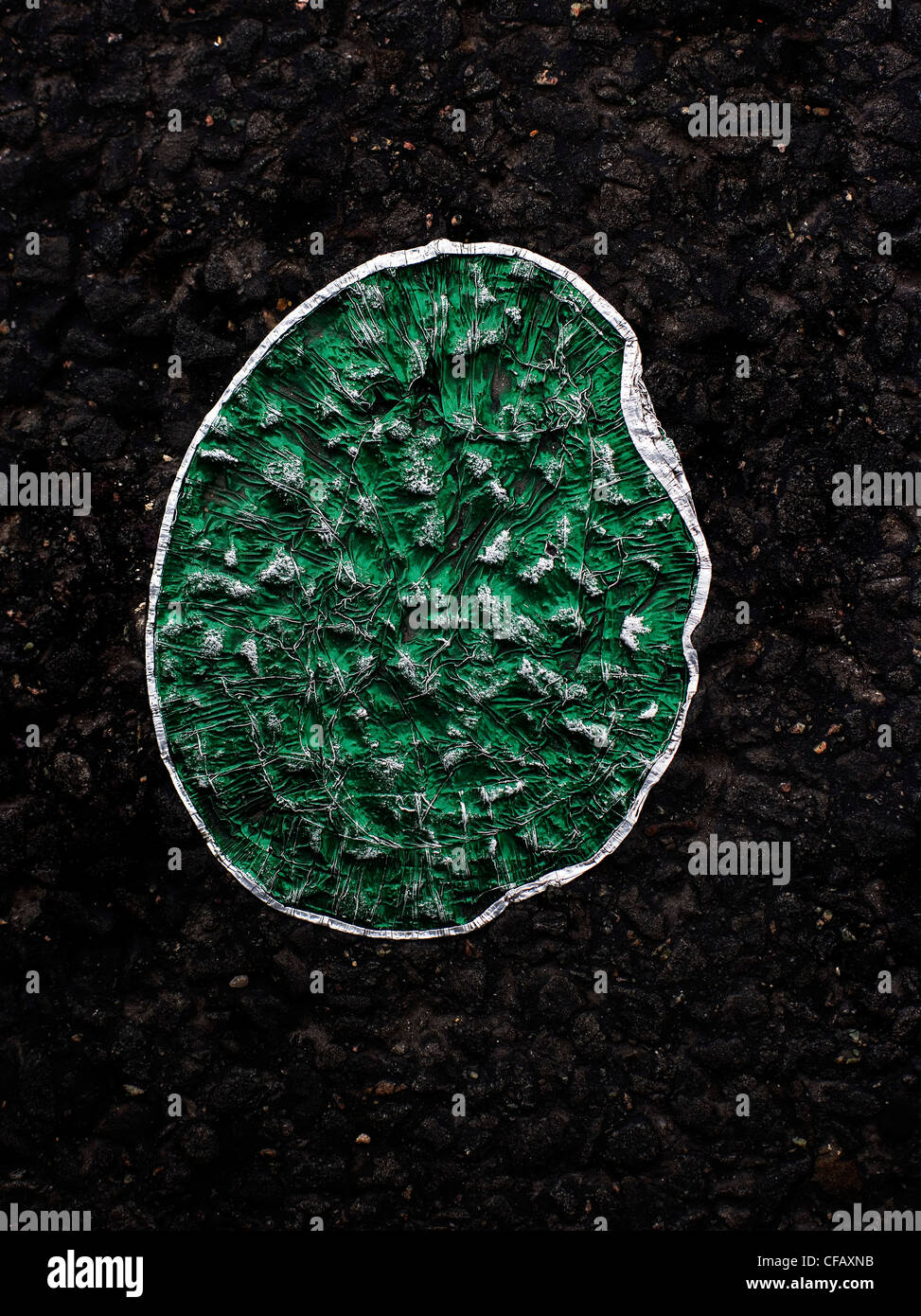 Squashed green can on London street Stock Photo - Alamy