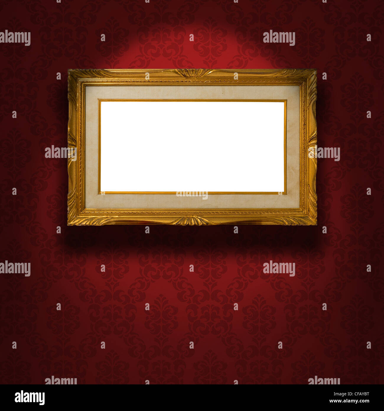 Empty golden frame illuminated from a spotlight. The frame is on the ...