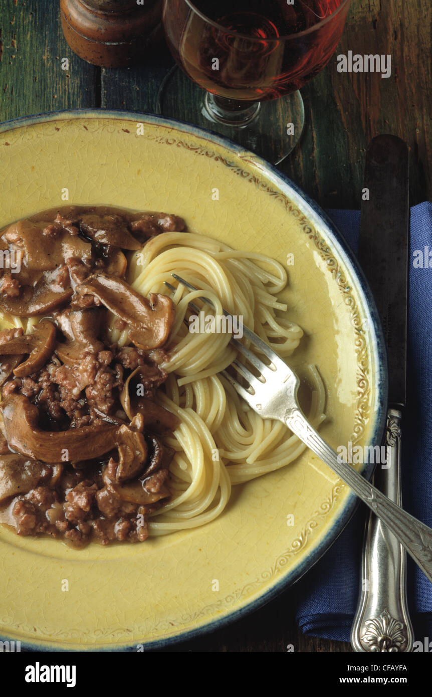 Ragout of fungi and sausage with spaghetti Stock Photo - Alamy