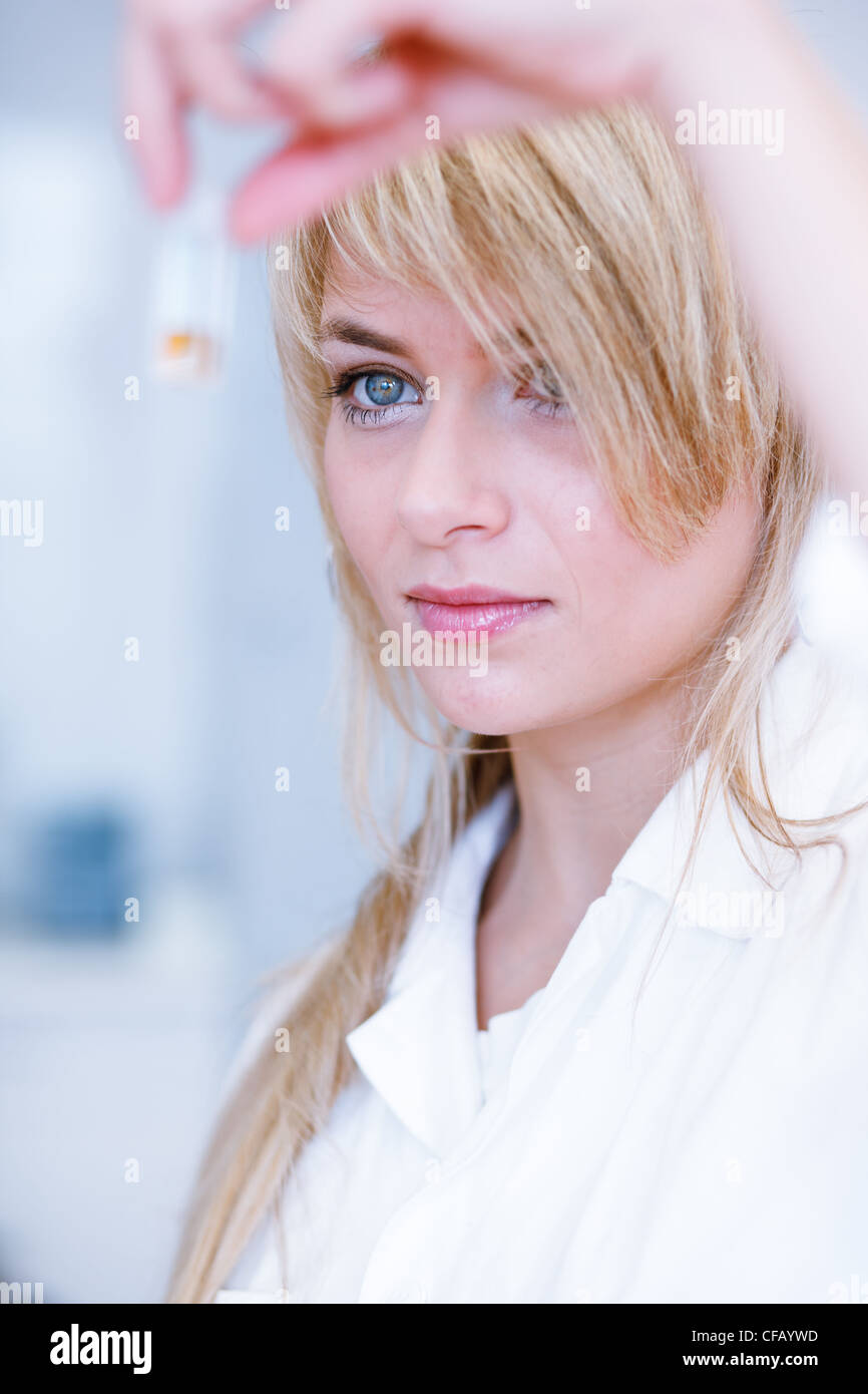 female researcher carrying out research experiments in a chemistry lab ...