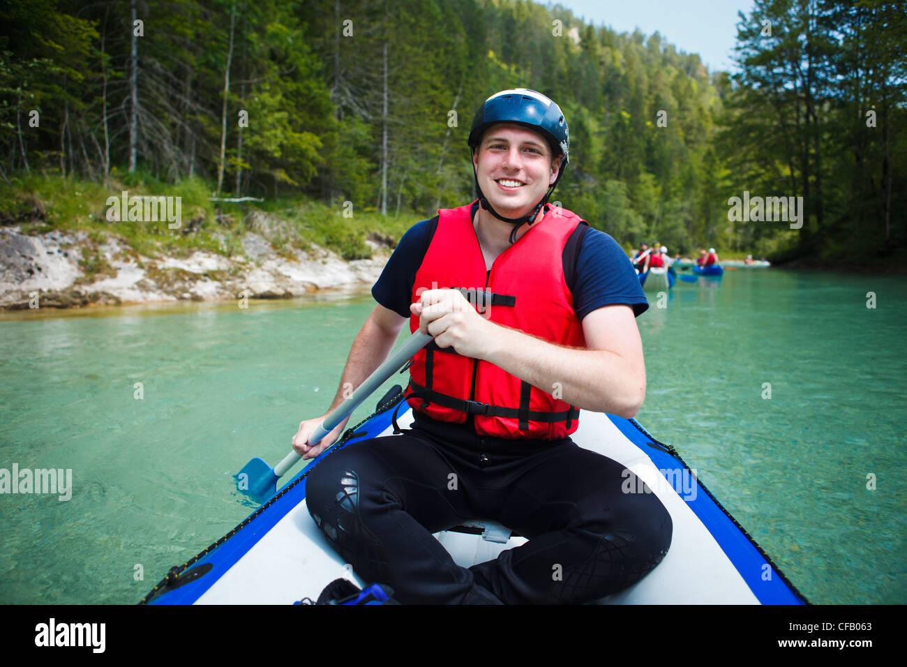 white water rafting - young man in a raft boat, paddling, smiling Stock ...