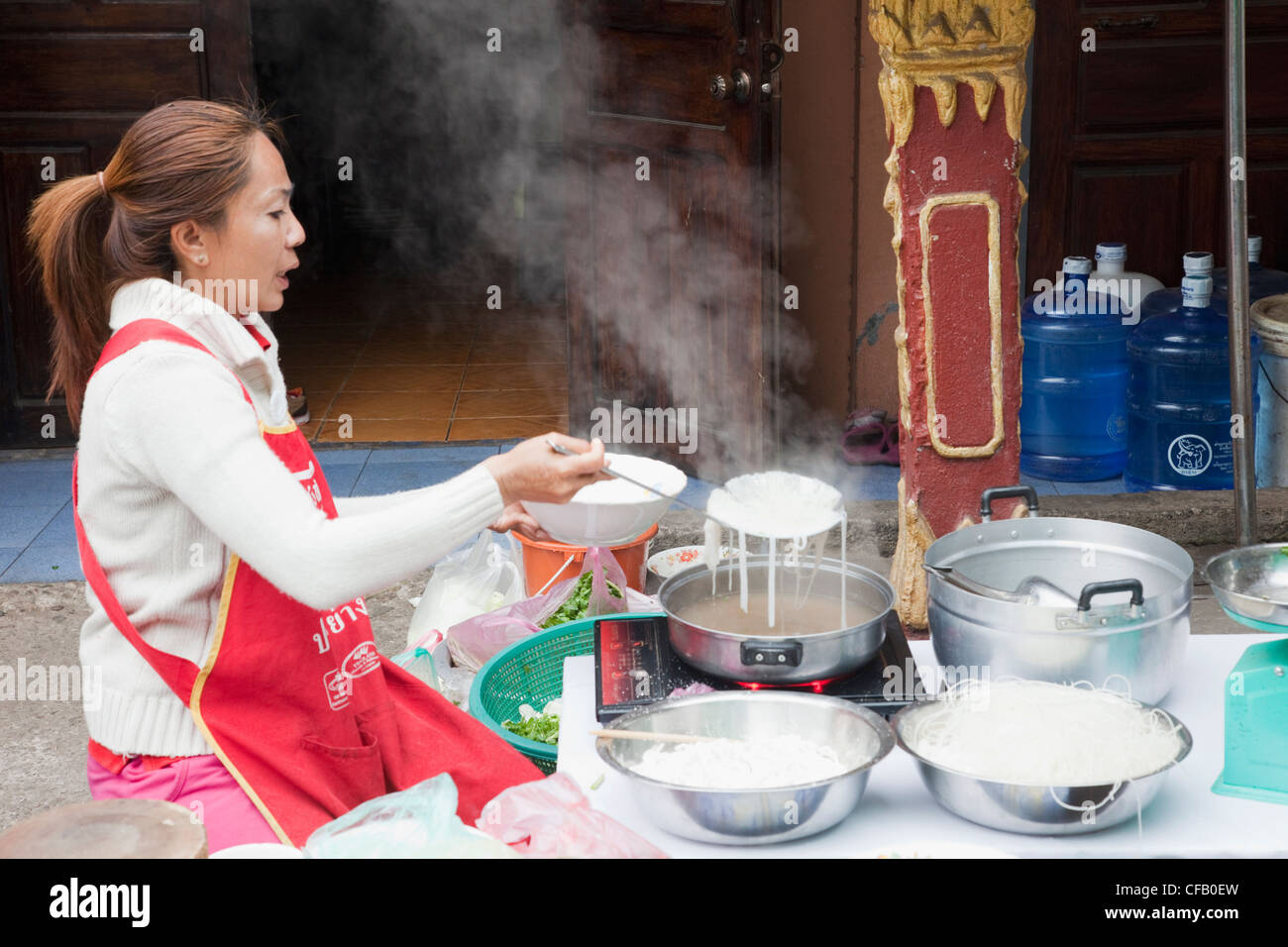 Woman cooking noodles hi-res stock photography and images - Alamy