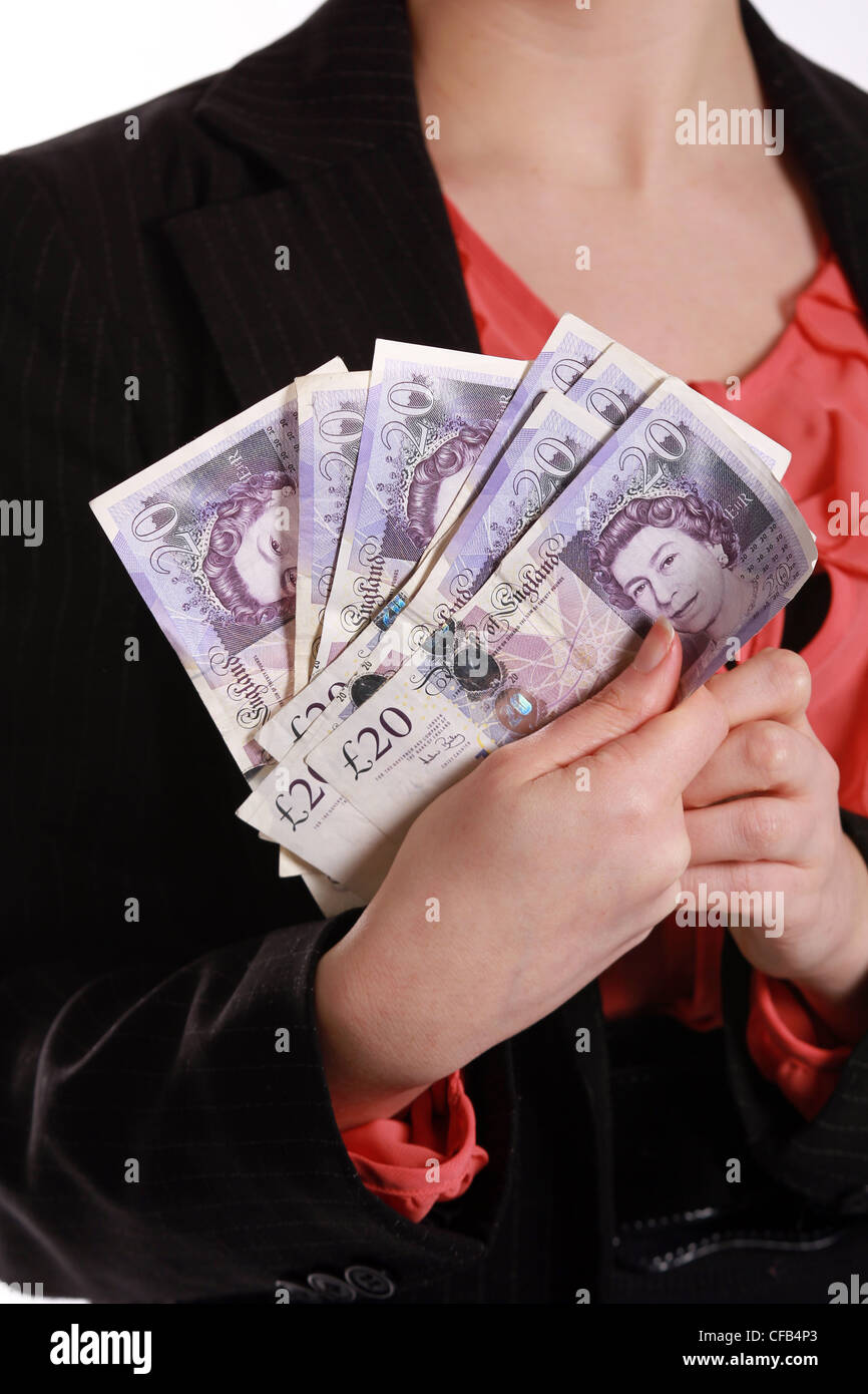 Woman holds a bundle of British Twenty pound notes Stock Photo - Alamy