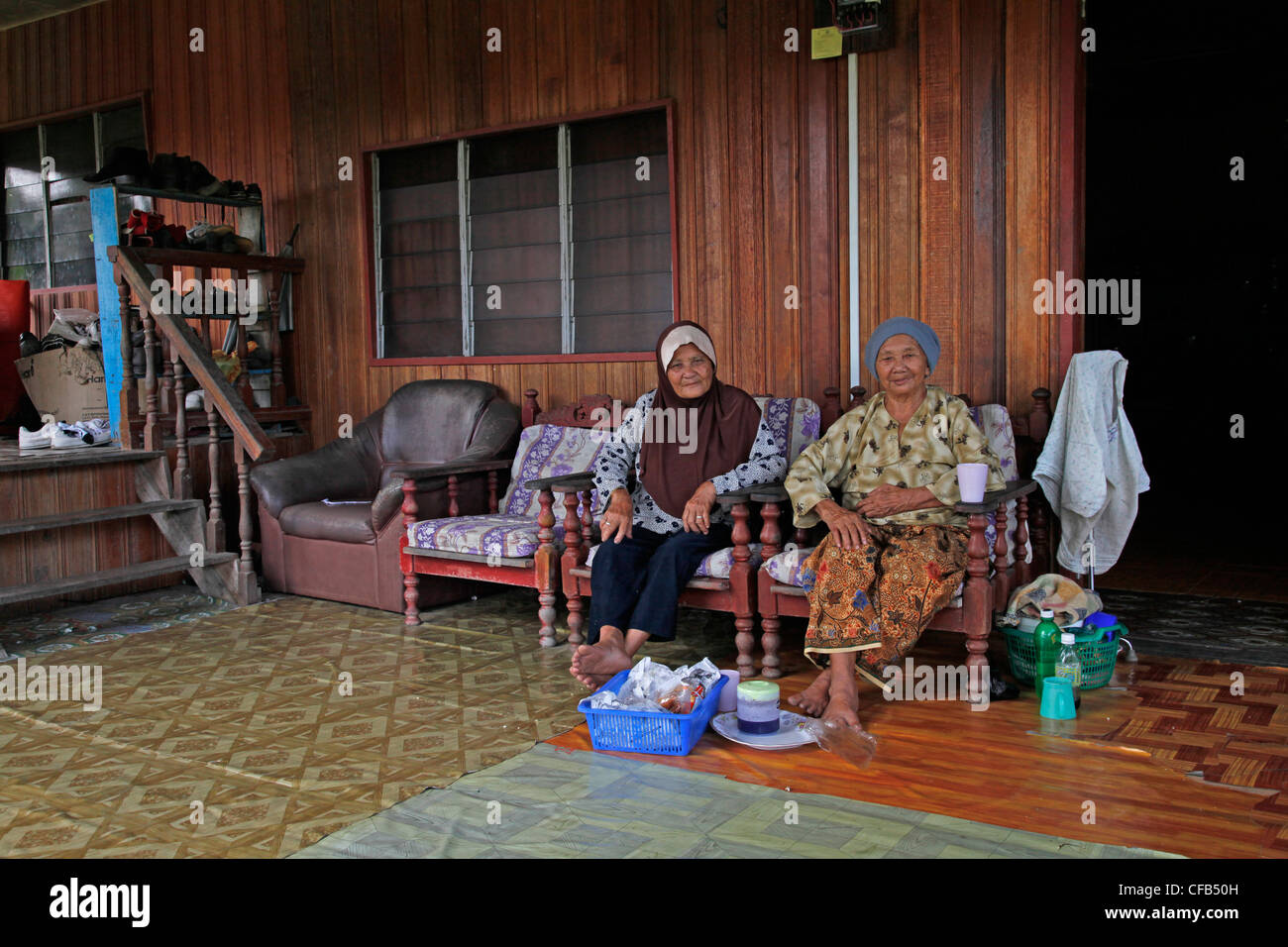 Traditional native Iban and Dayak family in a longhouse in Borneo ...