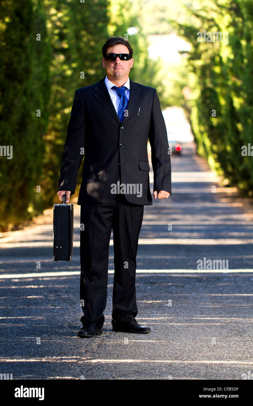 View of a young male business man on a asphalt road Stock Photo - Alamy