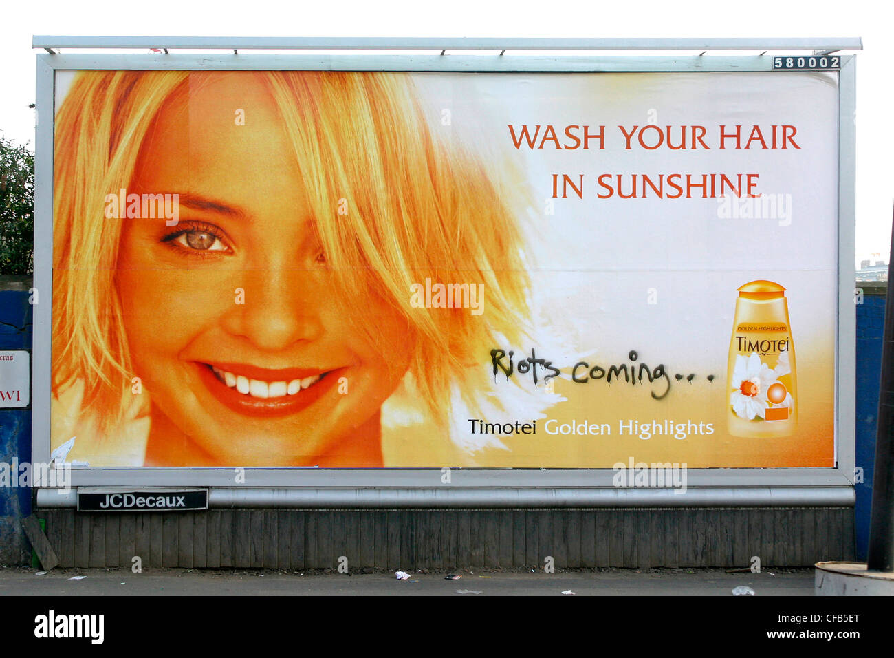 Shampoo advertising poster on the street which has the slogan "riots ...
