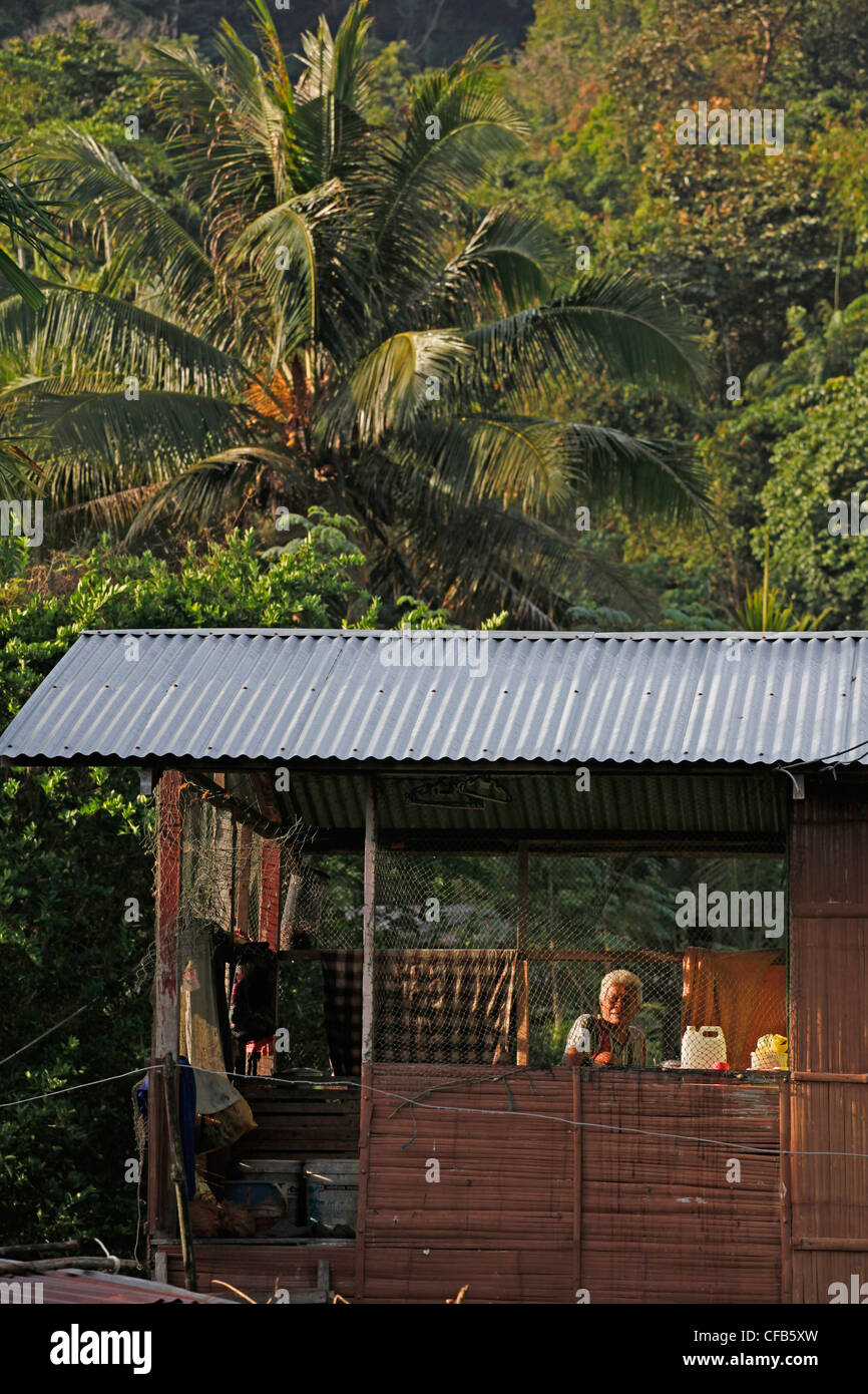 Traditional native Iban and Dayak family in a longhouse in Borneo ...