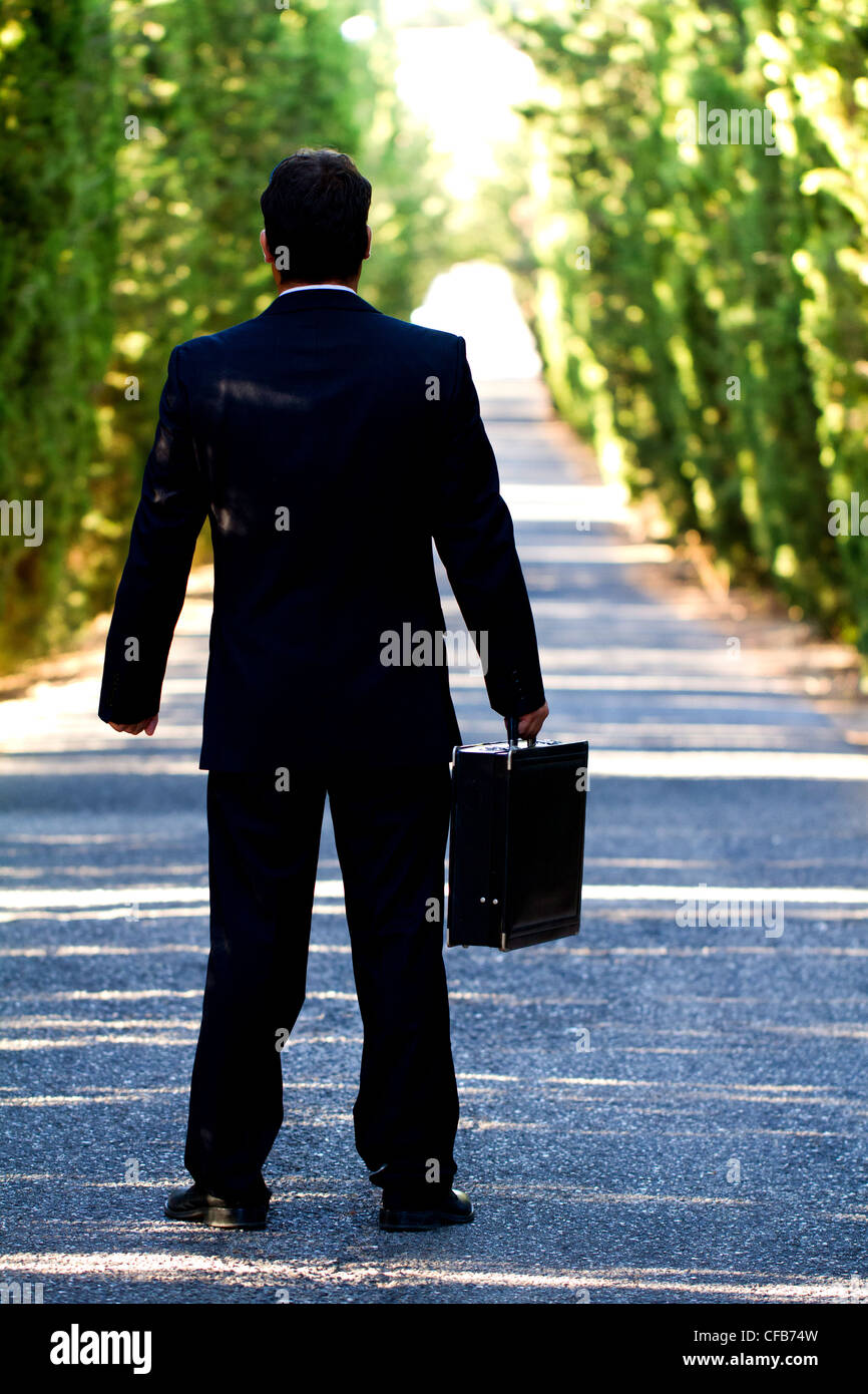 View of a young male business man on a asphalt road Stock Photo - Alamy