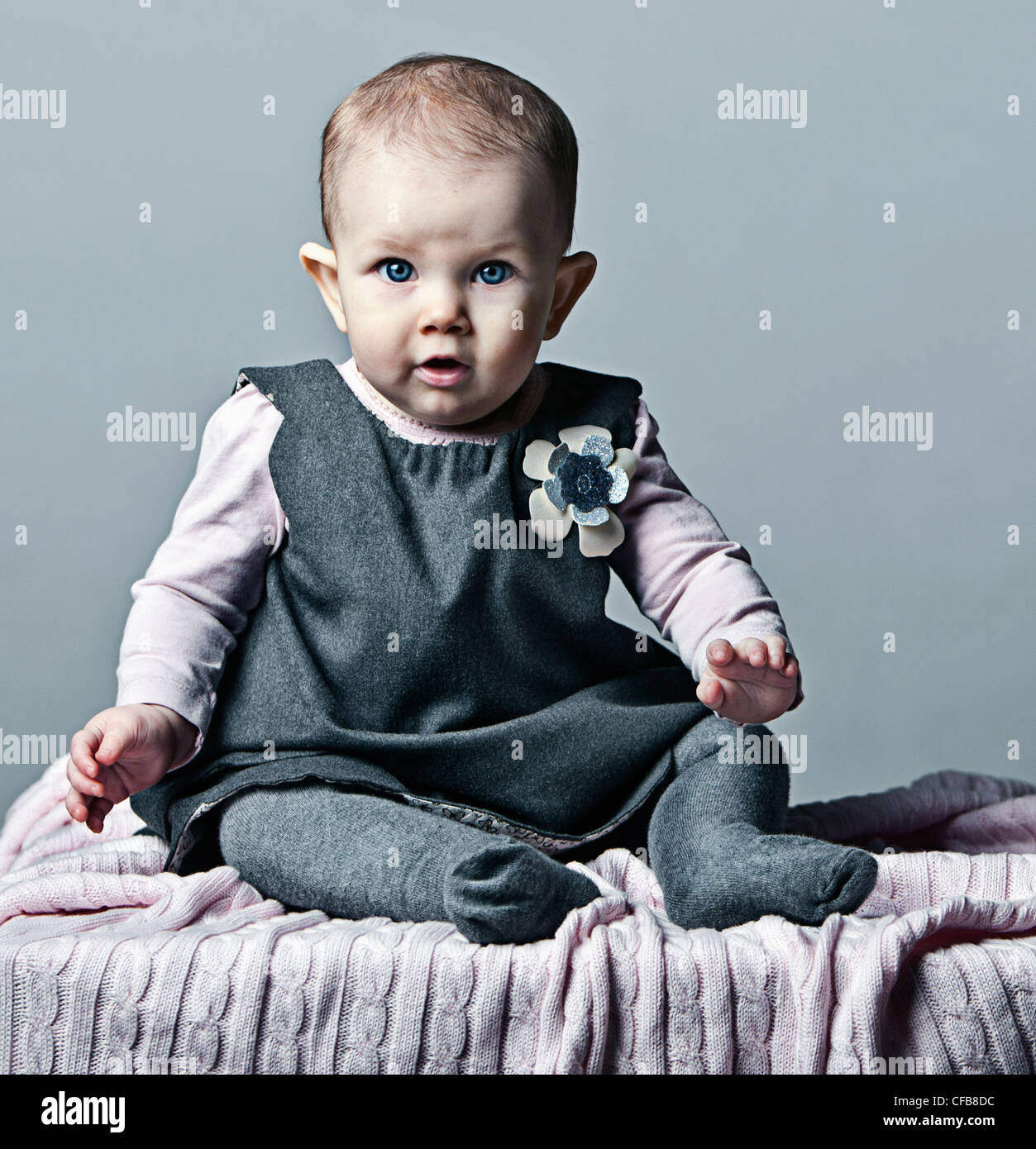 Beauty Baby girl in Grey Dress Stock Photo - Alamy