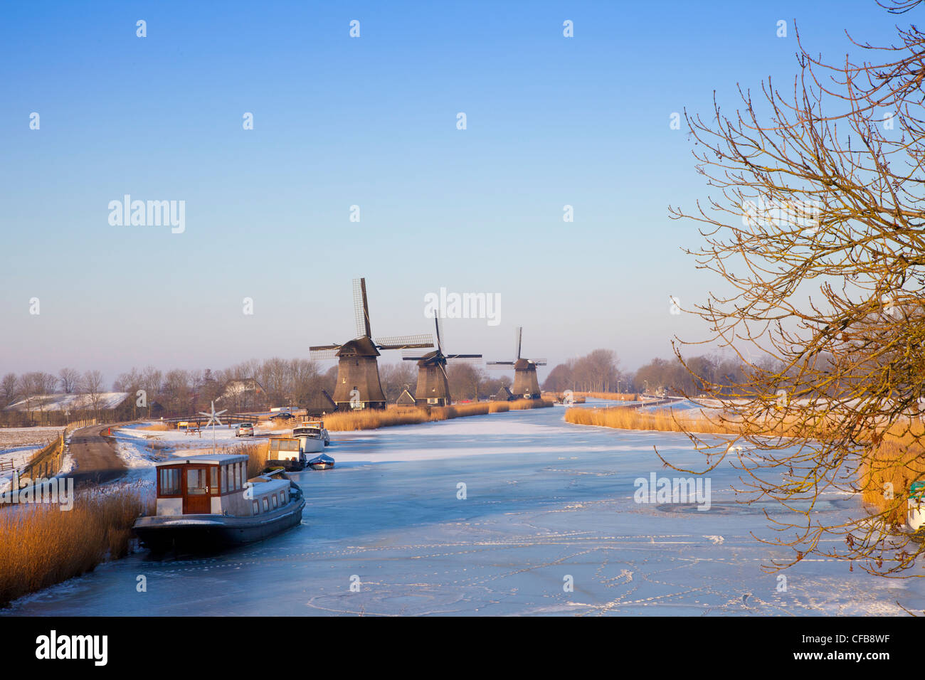 Windmill in winter time with snow and blue sky Stock Photo - Alamy