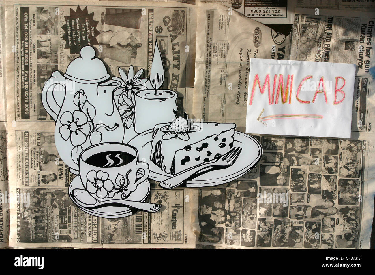 Mini cab office with cafe on a newsprint covered window, London, UK ...