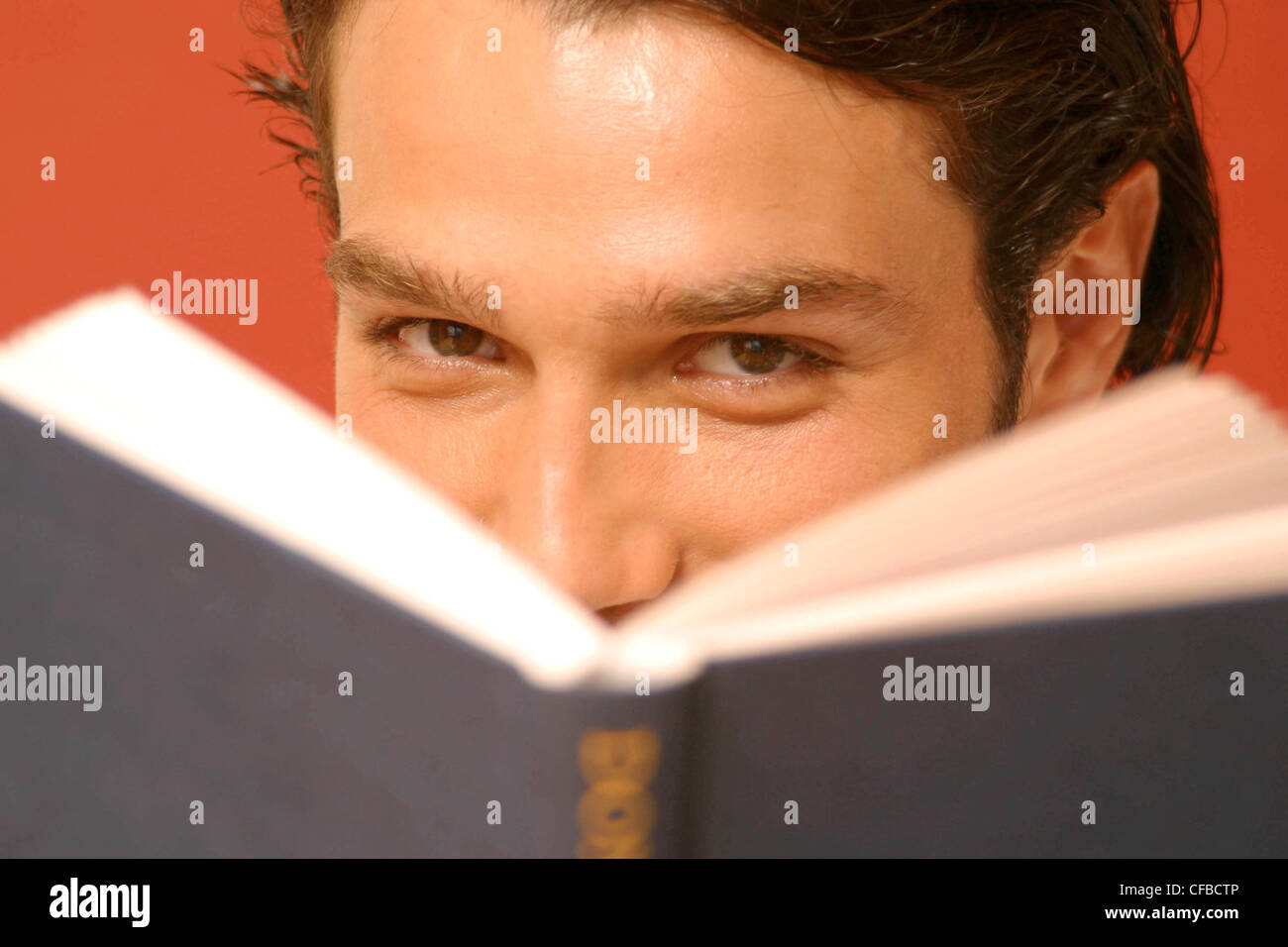 Cropped male with dark curly hair covering bottom half of face with ...