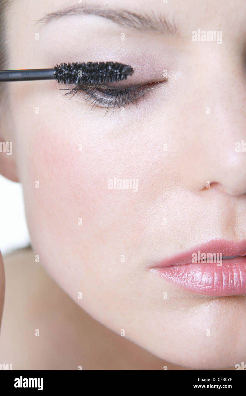 Close up of eye half nose and mouth of female brunette hair off face ...