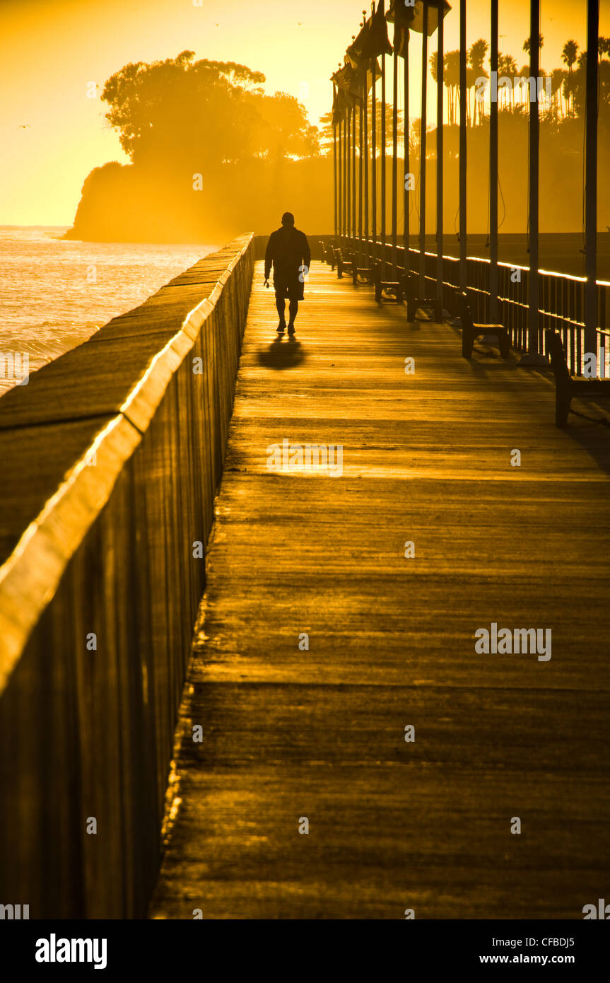 man walking sunset vertical Stock Photo - Alamy