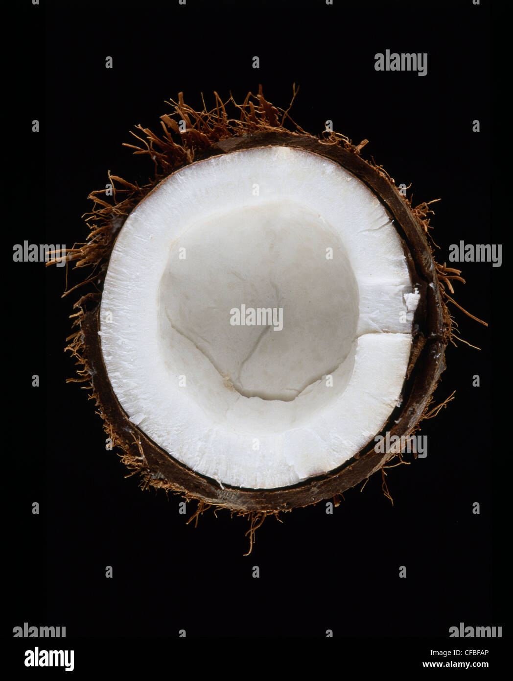 Aerial view of half a coconut, against black background Stock Photo - Alamy