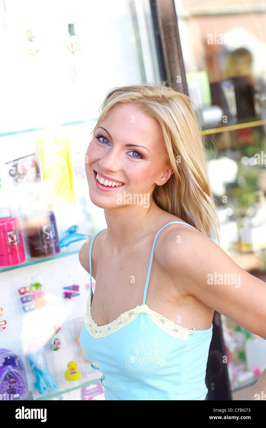 Female Shoulder Length Straight Blonde Hair Wearing Pale Blue Vest Top